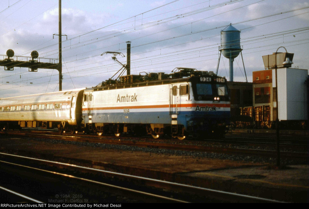 Amtrak AEM-7 #934 hustles an eastbound through the station at Frankford Junction in Philadelphia ...